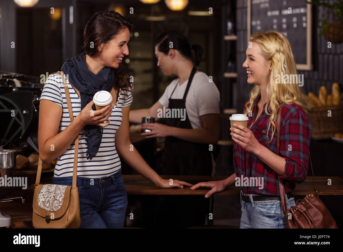 Smiling friends enjoying coffee Stock Photo - Alamy