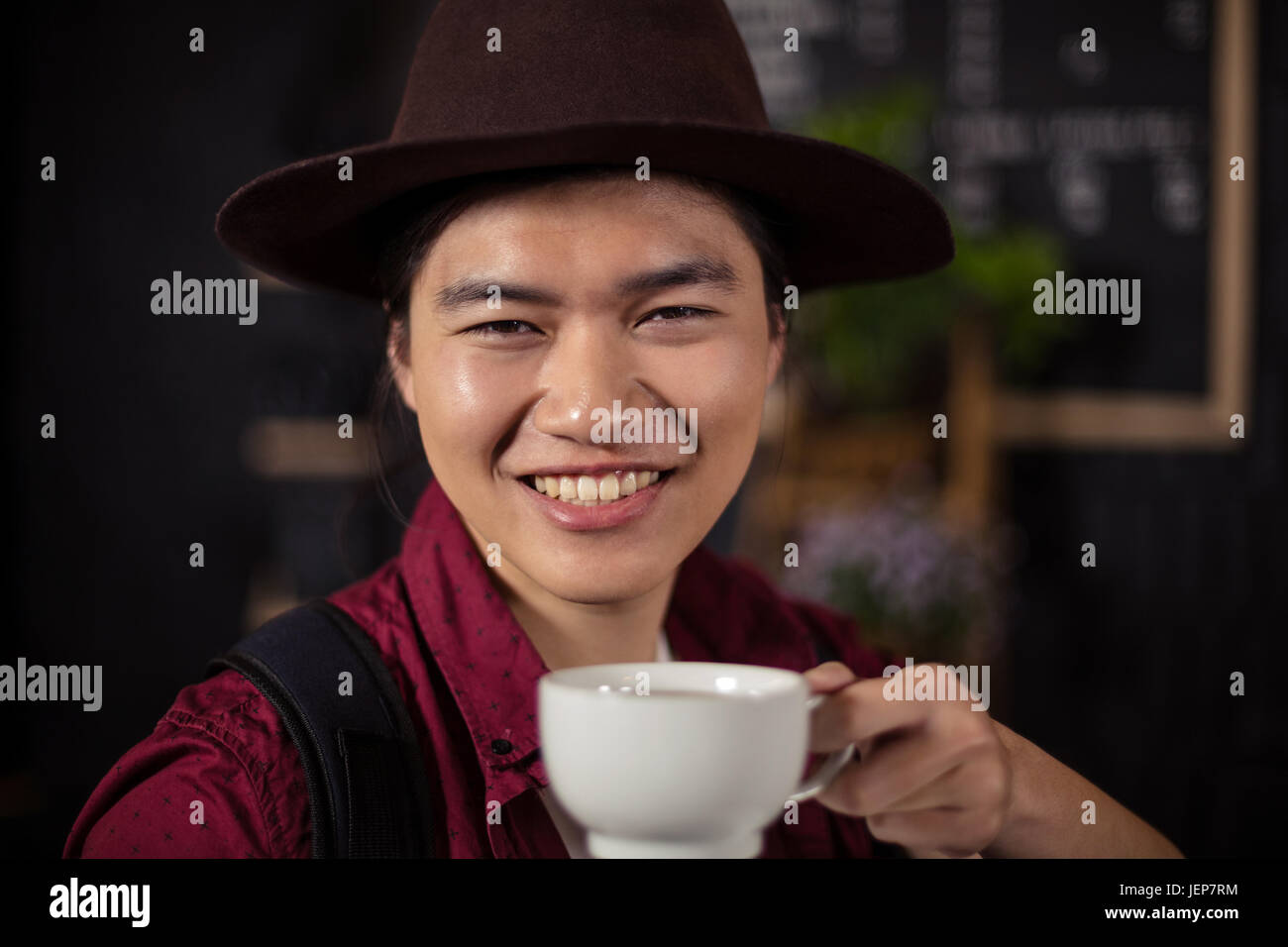 Happy customer drinking coffee Stock Photo - Alamy
