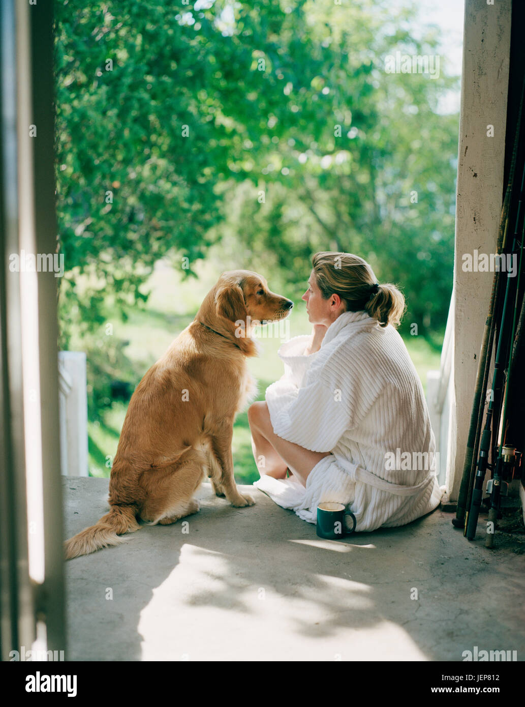 Woman sitting with dog Stock Photo - Alamy