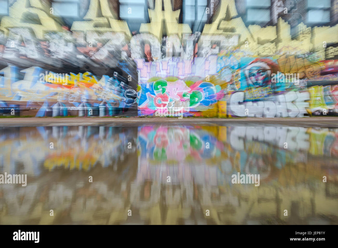 Graffiti reflecting in water Stock Photo - Alamy