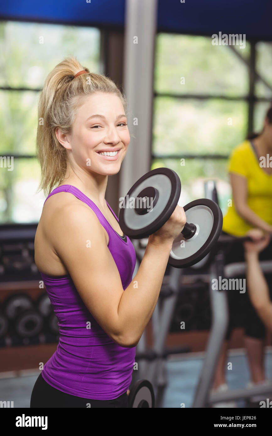 Fit woman lifting dumbbell Stock Photo - Alamy