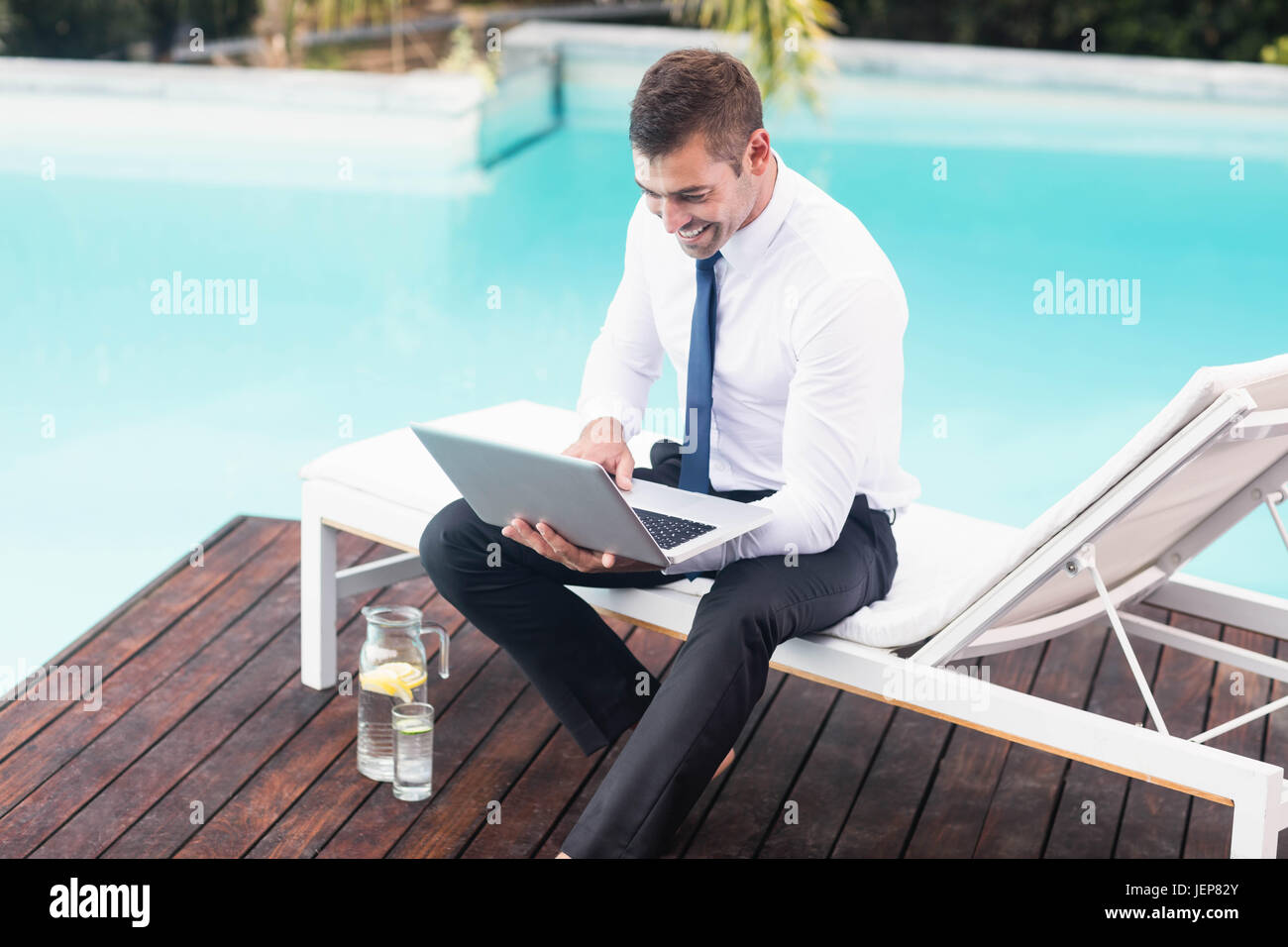 Smarty dressed man using laptop Stock Photo - Alamy