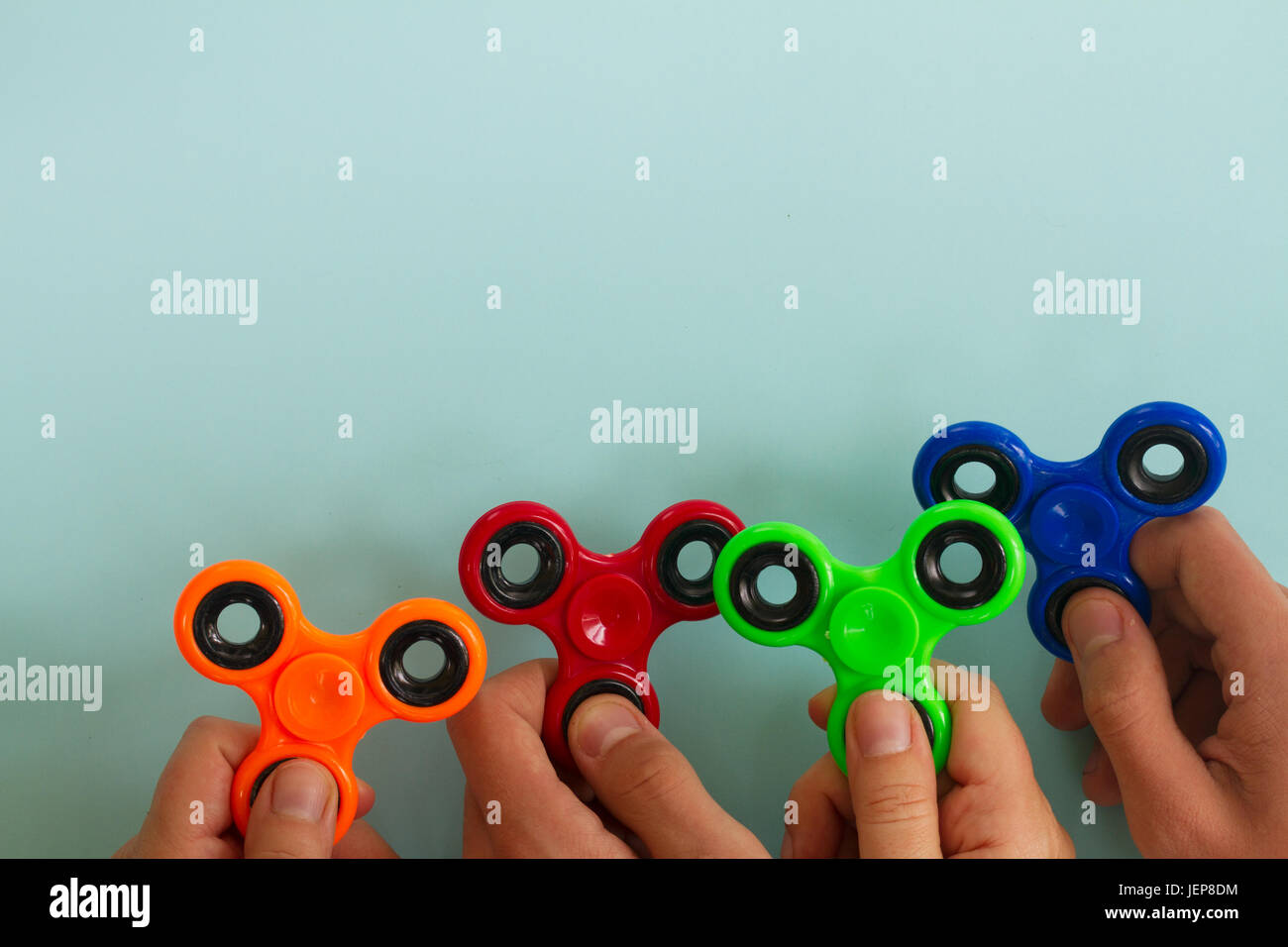 trendy fidget spinners - styled flat lay scene with someones hands ...