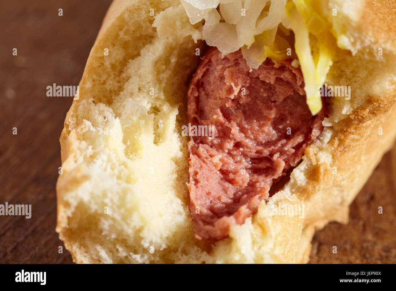 half-eaten hot dog in a bun topped with cole slaw Stock Photo - Alamy