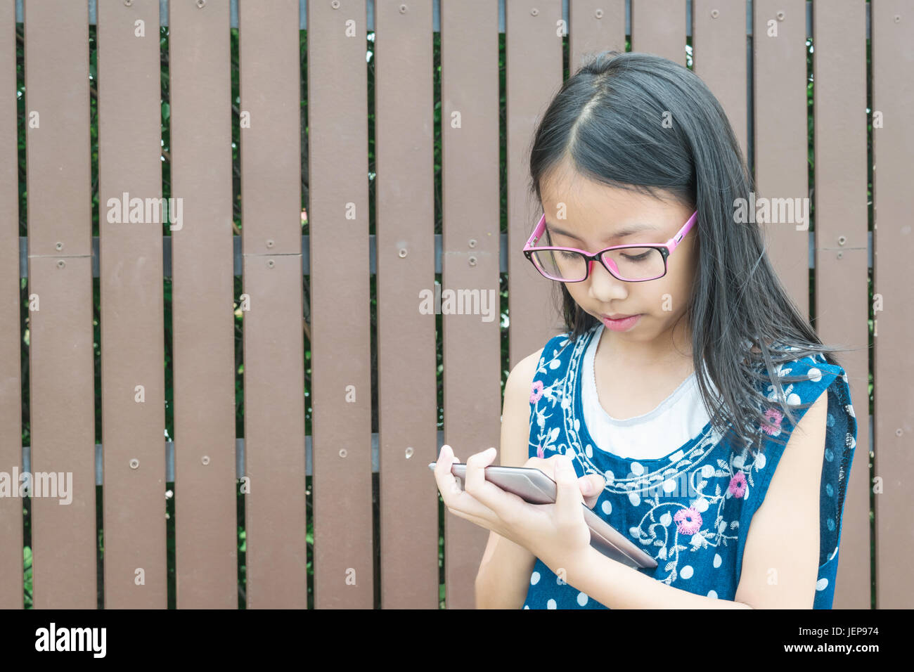 Beautiful girl using tablet to learning in the park. Concept technology ...