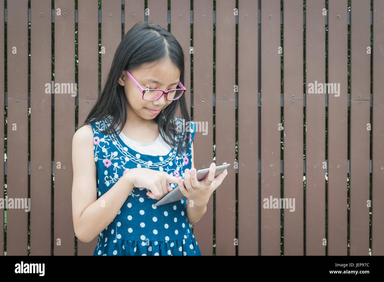 Portrait of beautiful little asian girl in the garden. Concept little ...