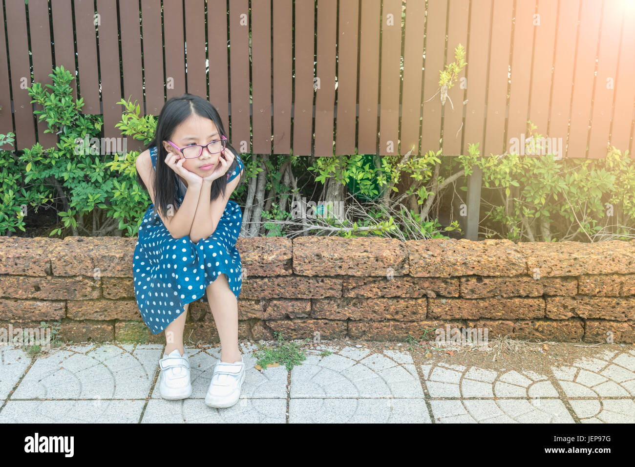 Portrait of beautiful little asian girl in the garden. Concept little ...