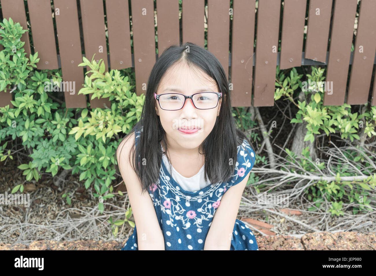 Portrait of beautiful little asian girl in the garden. Concept little ...