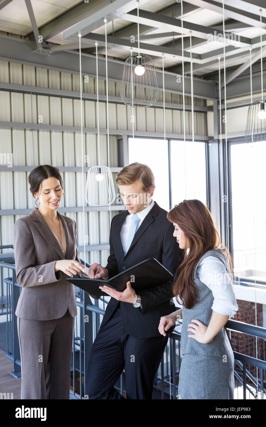 Three colleagues discussing in office Stock Photo - Alamy