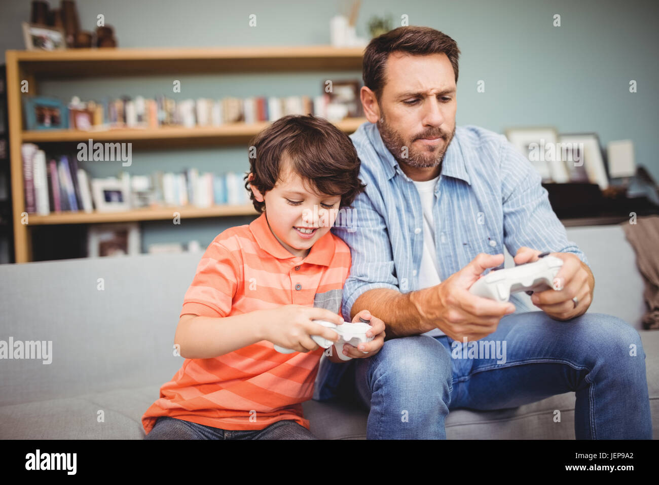 Father and son playing video game Stock Photo - Alamy