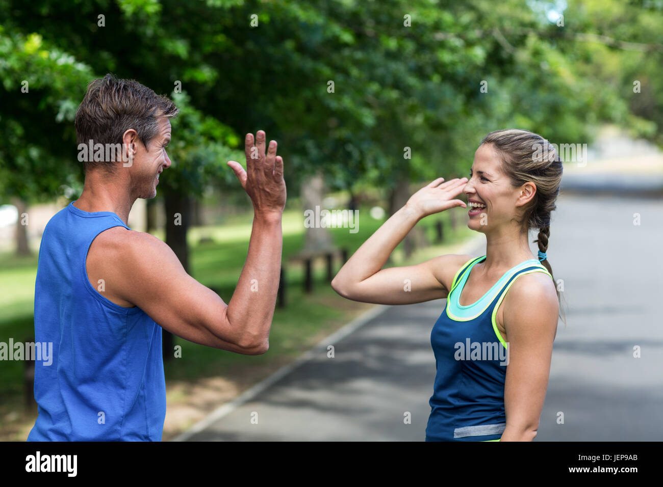 Fit people doing high five Stock Photo - Alamy
