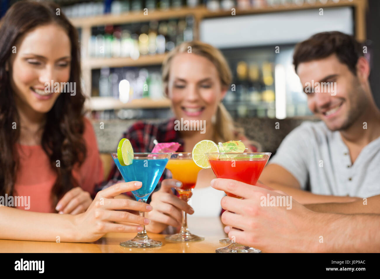 Friends toasting with cocktails Stock Photo - Alamy