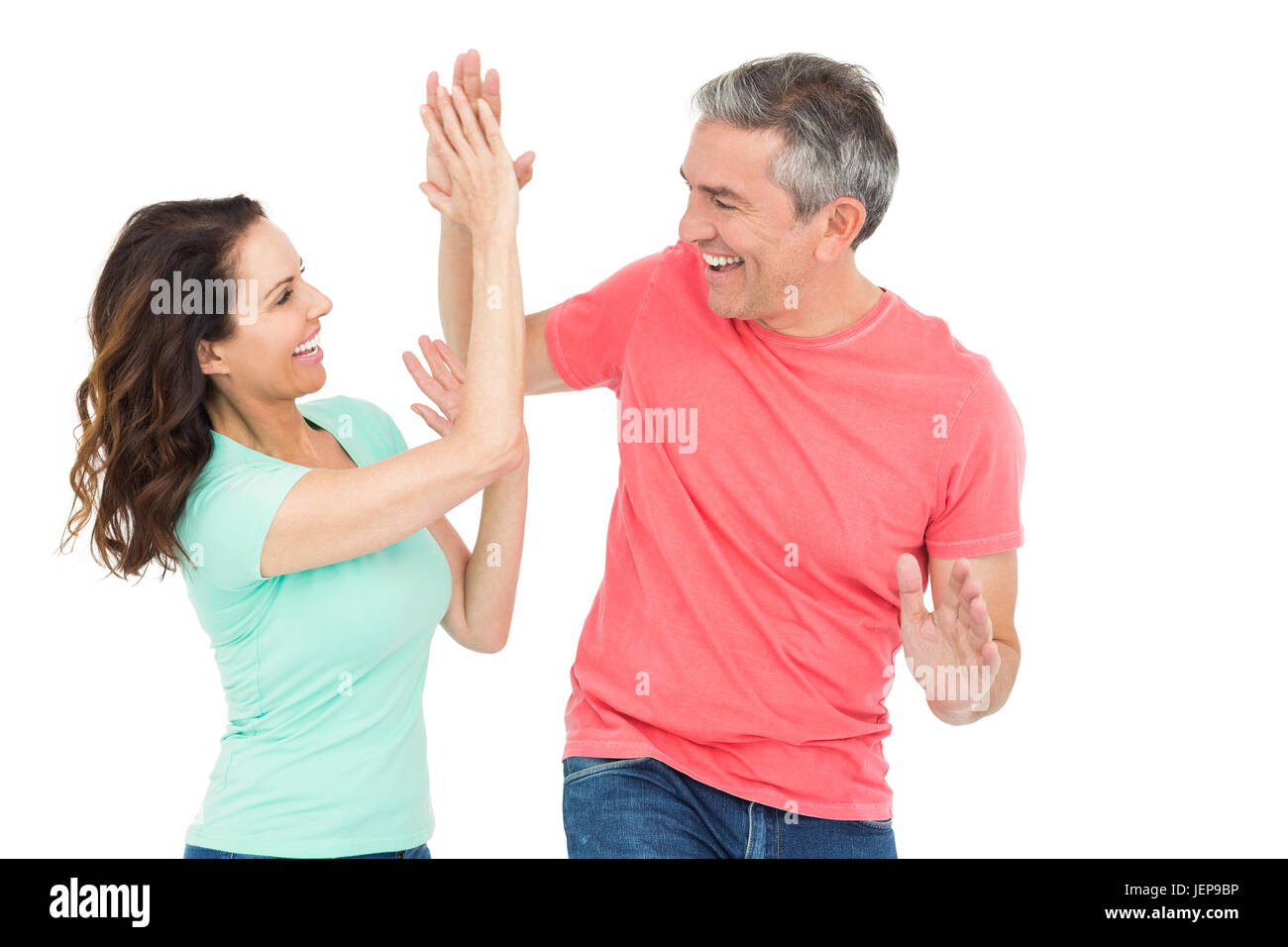 Excited couple giving a high-five Stock Photo - Alamy
