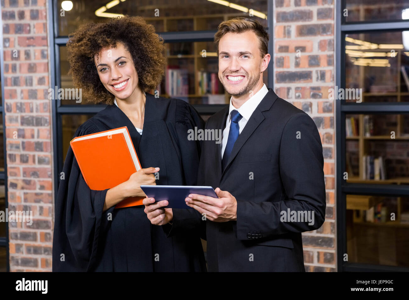 Businessman and lawyer standing near library Stock Photo - Alamy