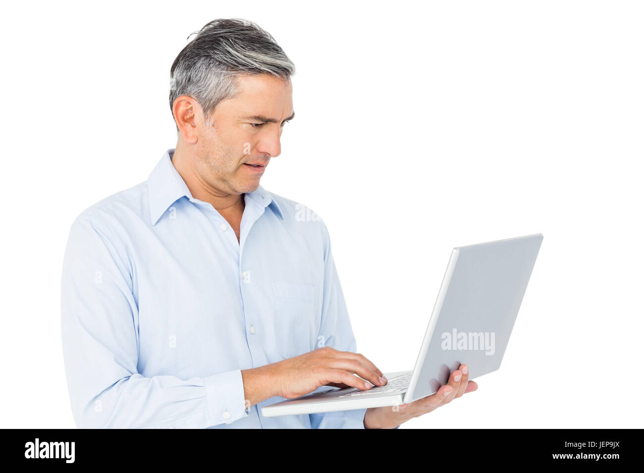 Smiling businessman typing on laptop Stock Photo - Alamy