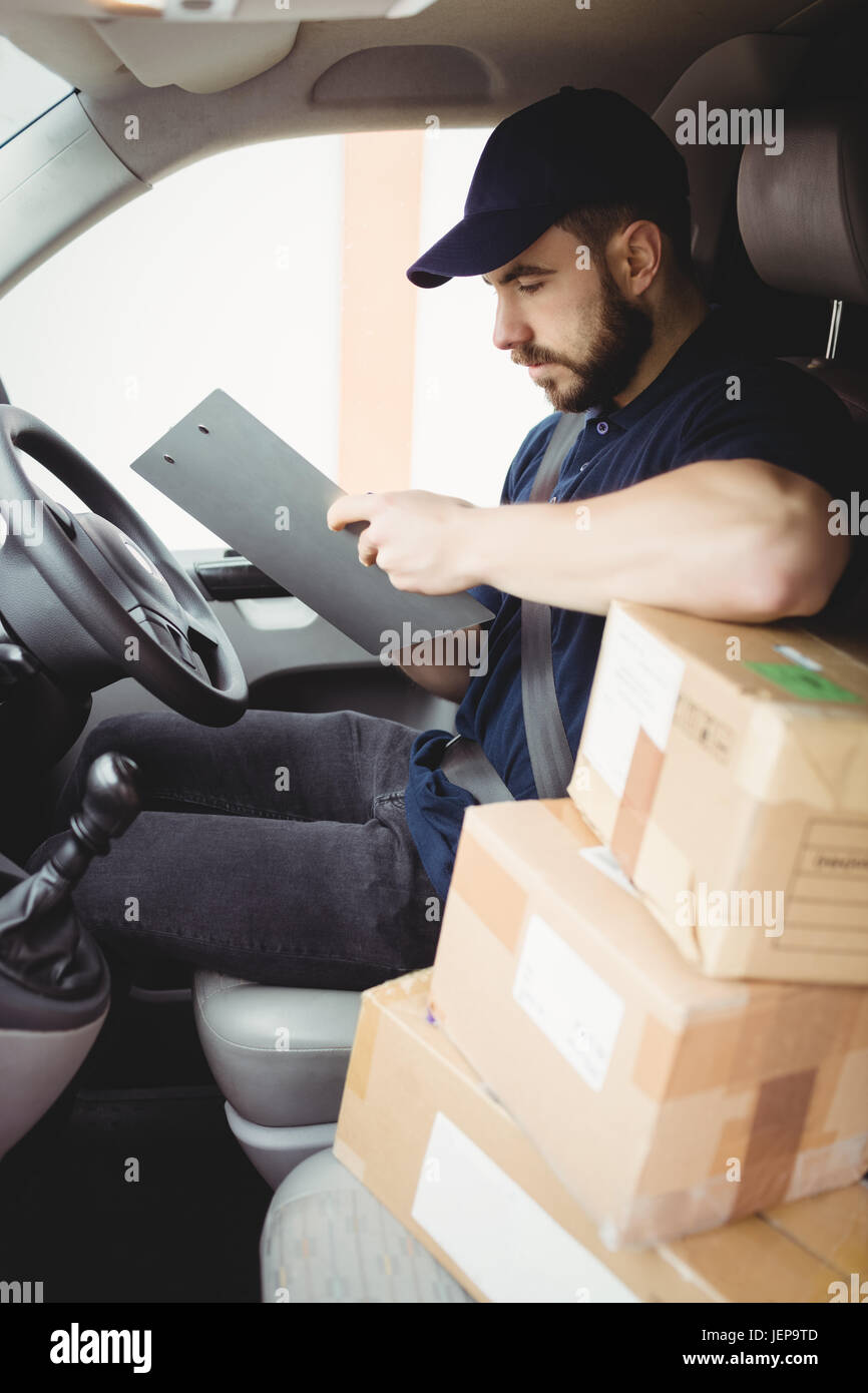 Delivery man sitting in his van Stock Photo - Alamy