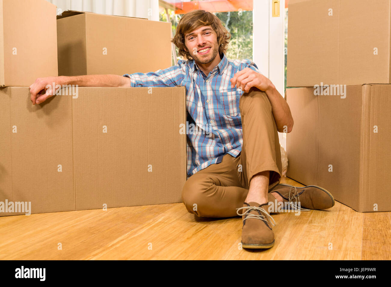 Handsome man posing with moving boxes Stock Photo - Alamy