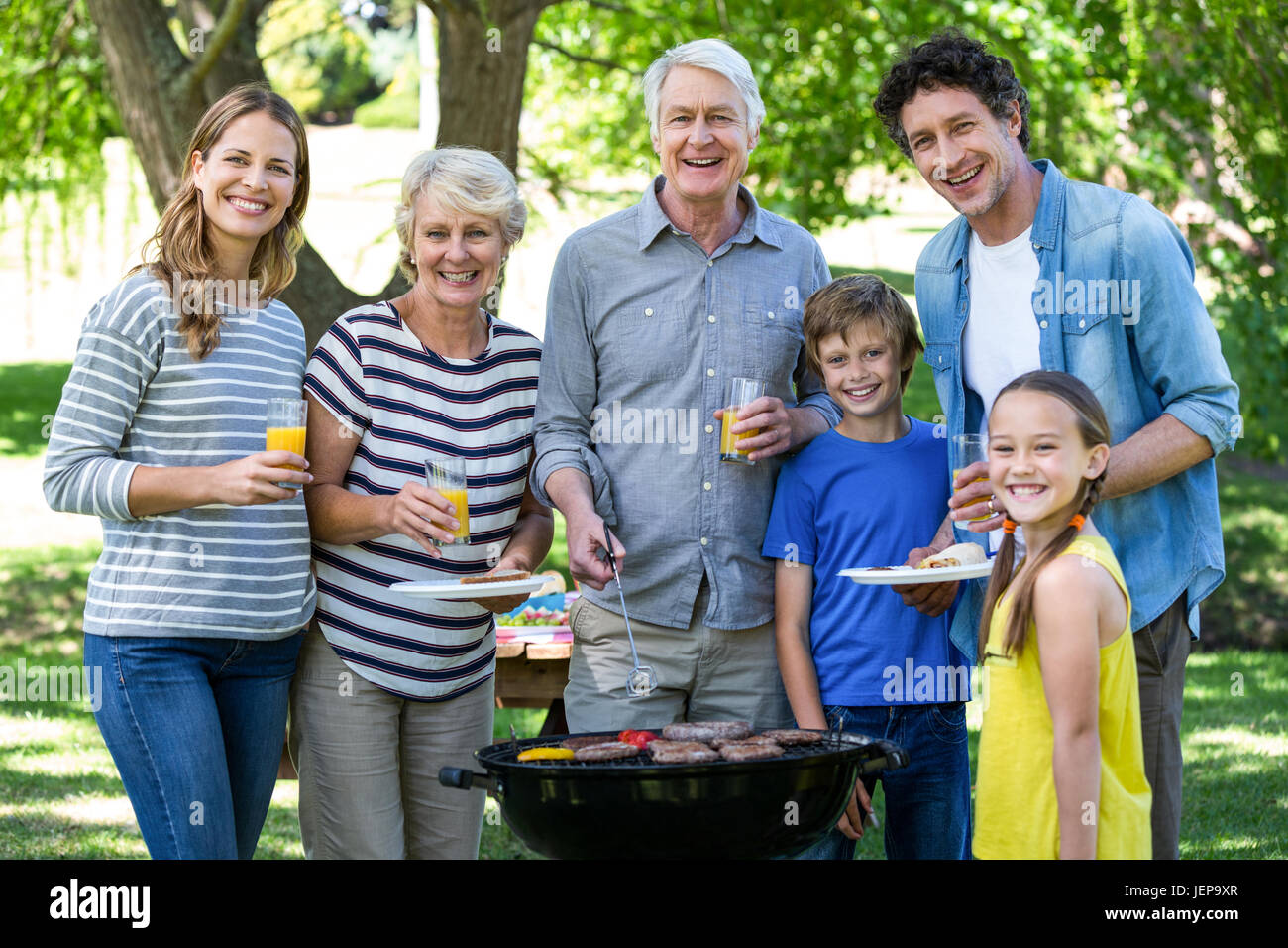 Family having a barbecue Stock Photo - Alamy