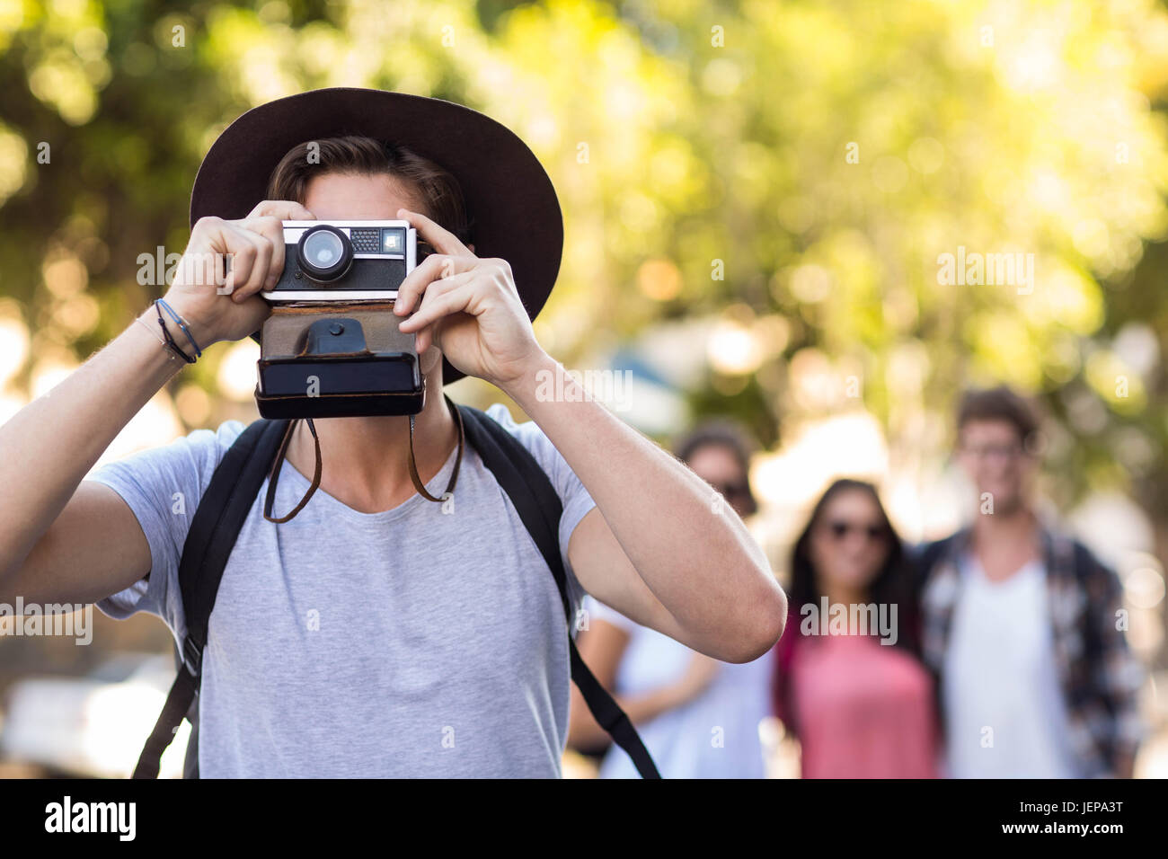 Hip man taking picture with polaroid Stock Photo - Alamy