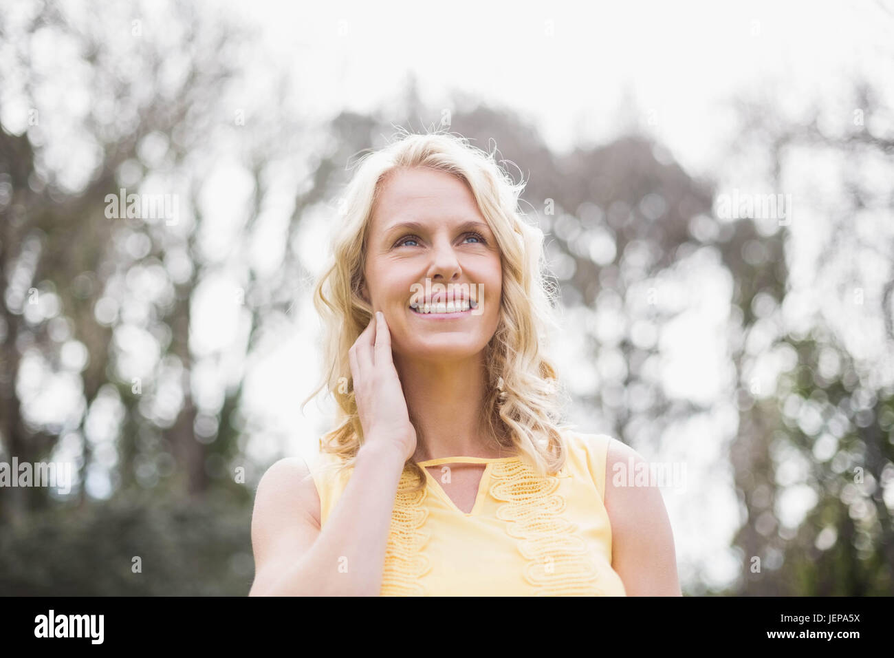 Cute woman smiling at camera Stock Photo - Alamy