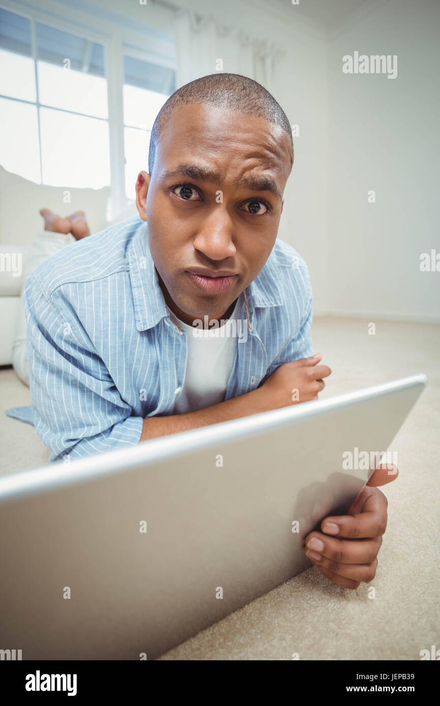 Handsome man lying on the floor Stock Photo - Alamy