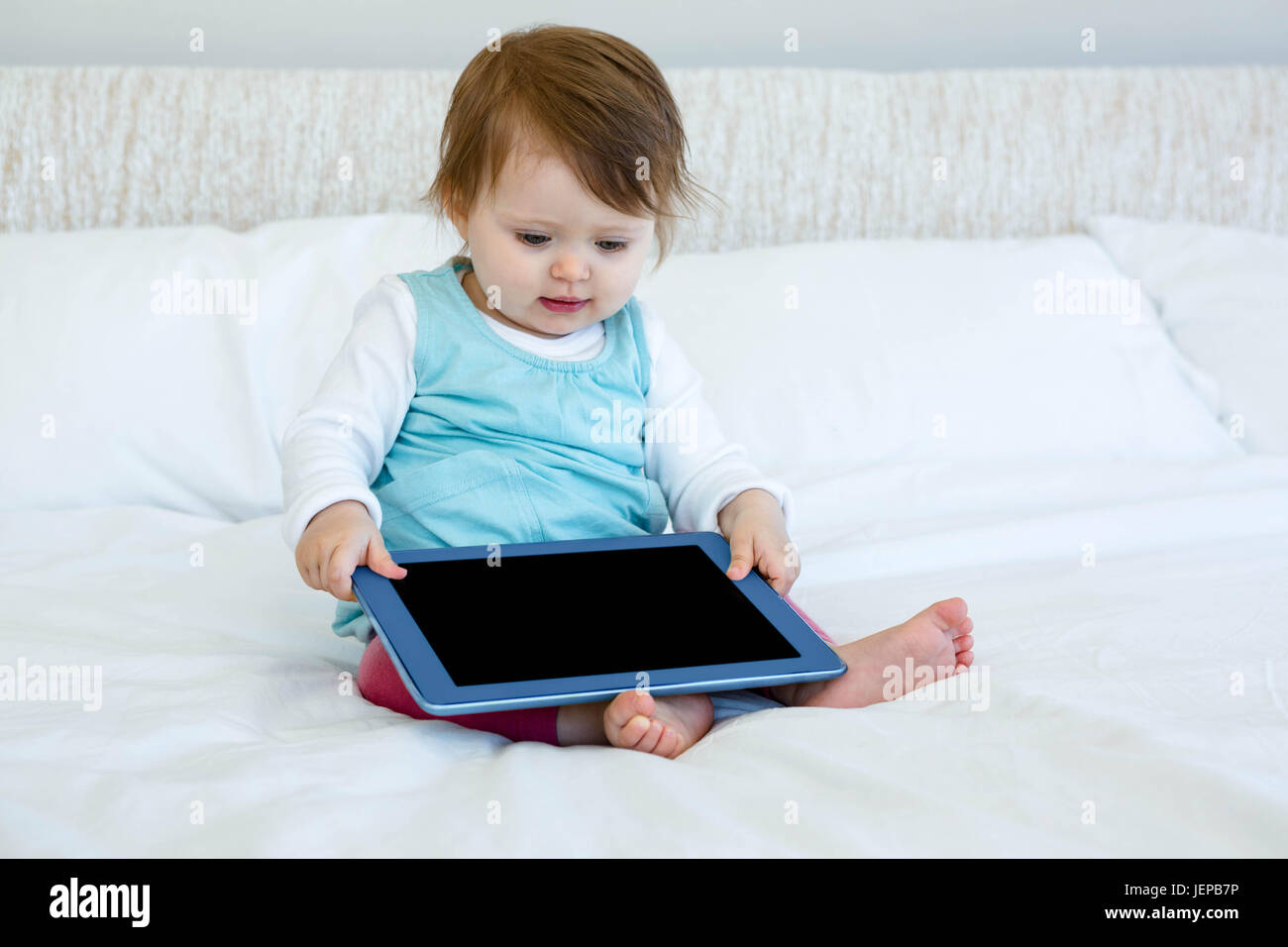adorable baby holding aa tablet computer Stock Photo - Alamy