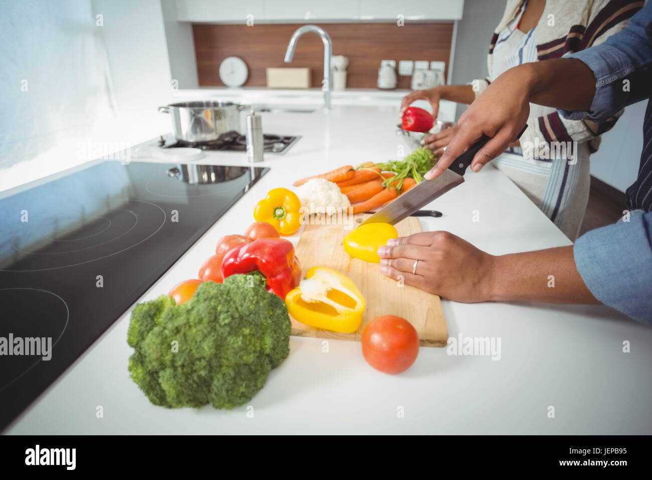 Mid section of couple preparing vegetables Stock Photo - Alamy