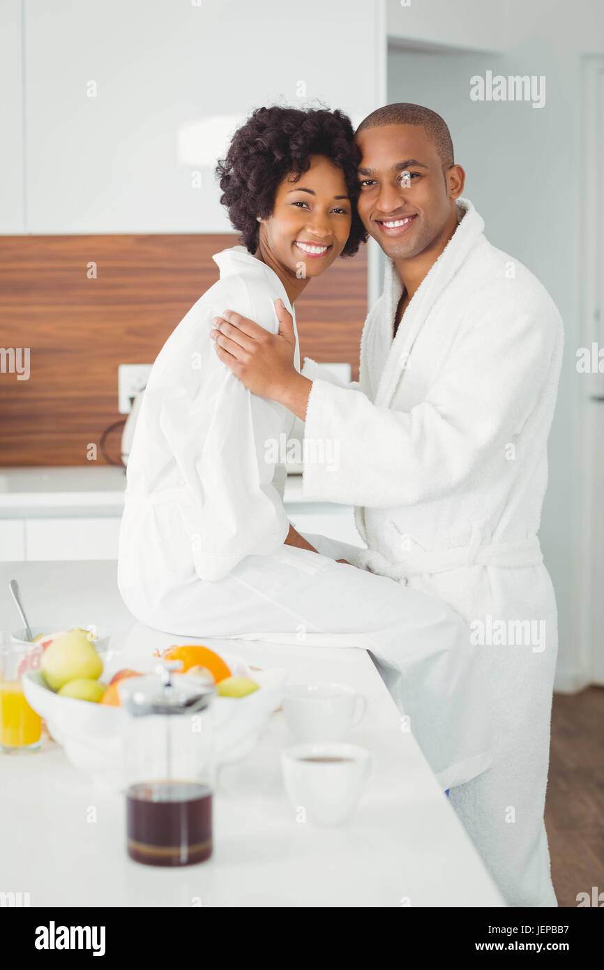 Happy couple hugging in the kitchen Stock Photo - Alamy