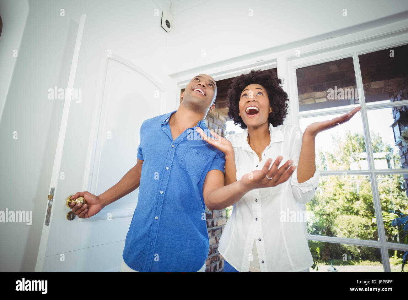 Happy couple entering in their house Stock Photo - Alamy
