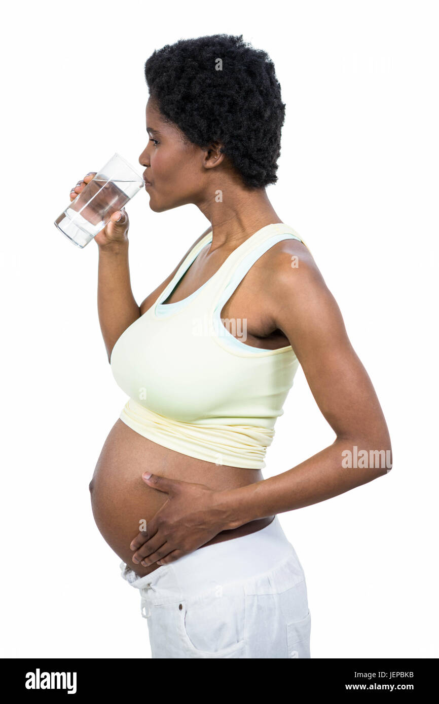Pregnant woman drinking water Stock Photo - Alamy
