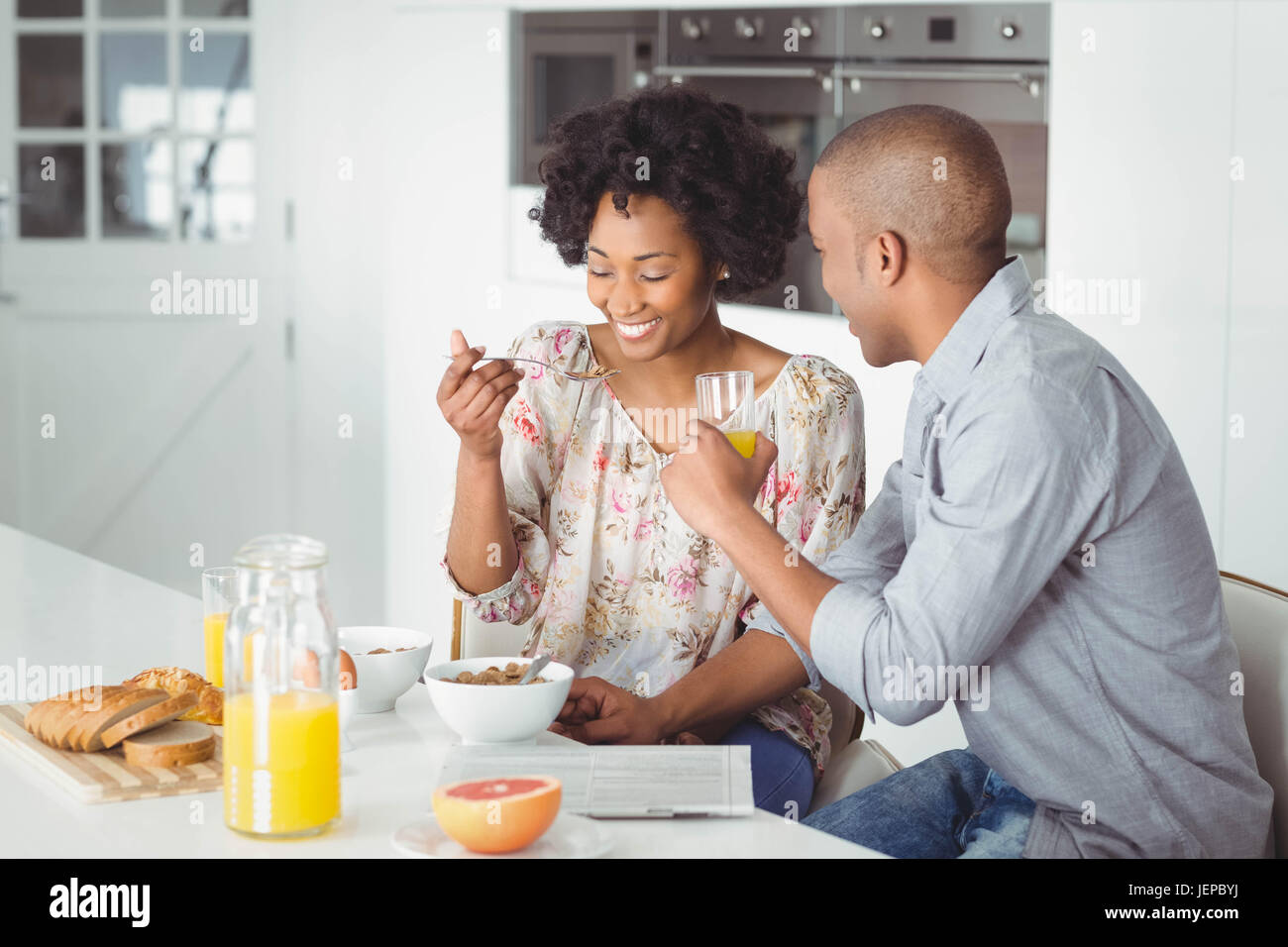 Smiling couple having breakfast together Stock Photo - Alamy