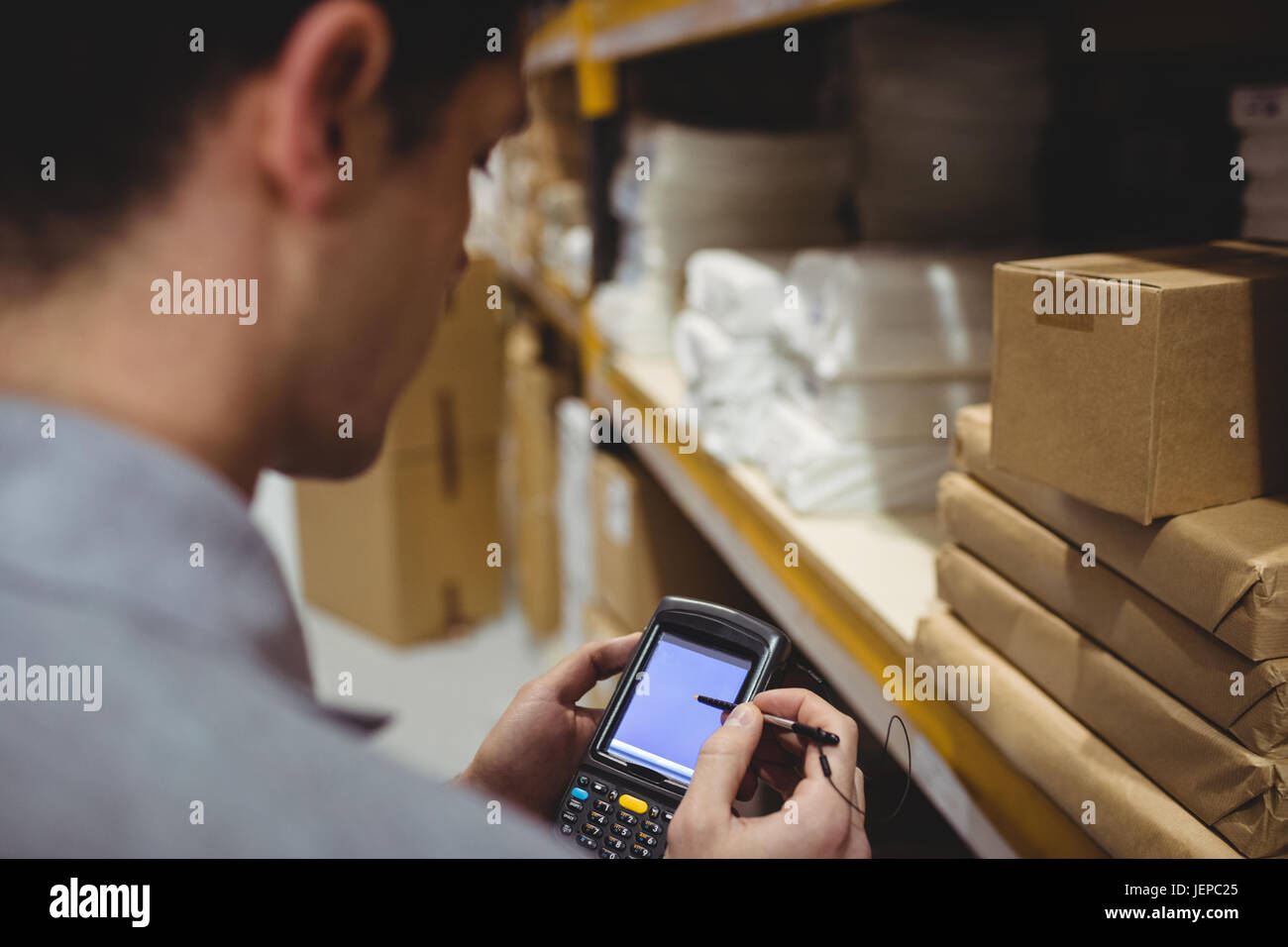 Warehouse worker scanning box Stock Photo - Alamy