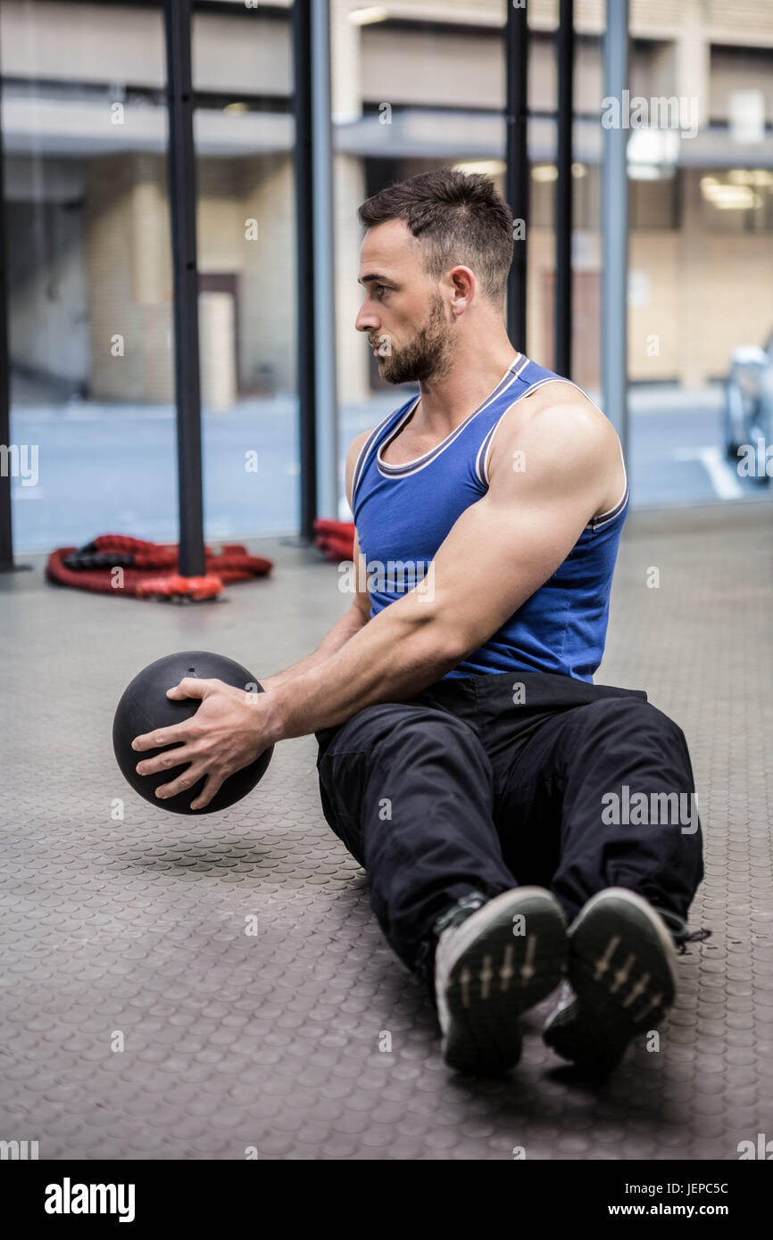Muscular man training with exercise ball Stock Photo - Alamy