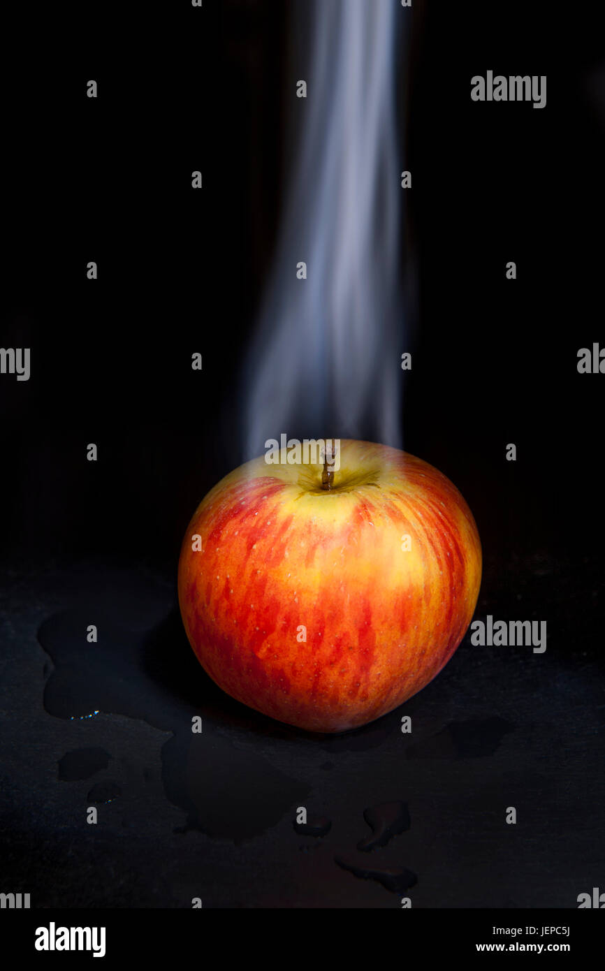 An apple with smoke coming off it Stock Photo - Alamy