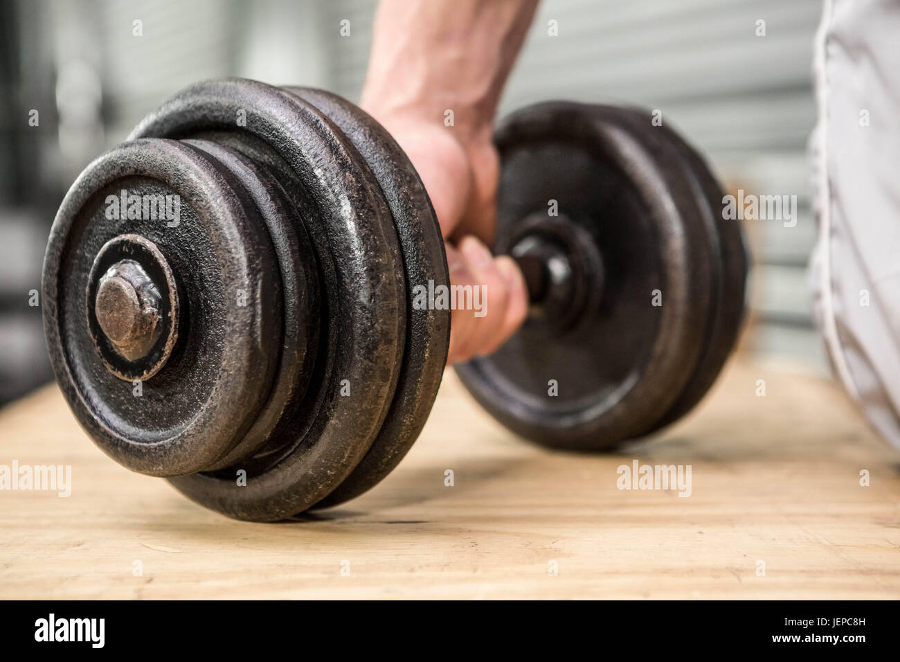 Close up of man holding dumbbell Stock Photo - Alamy