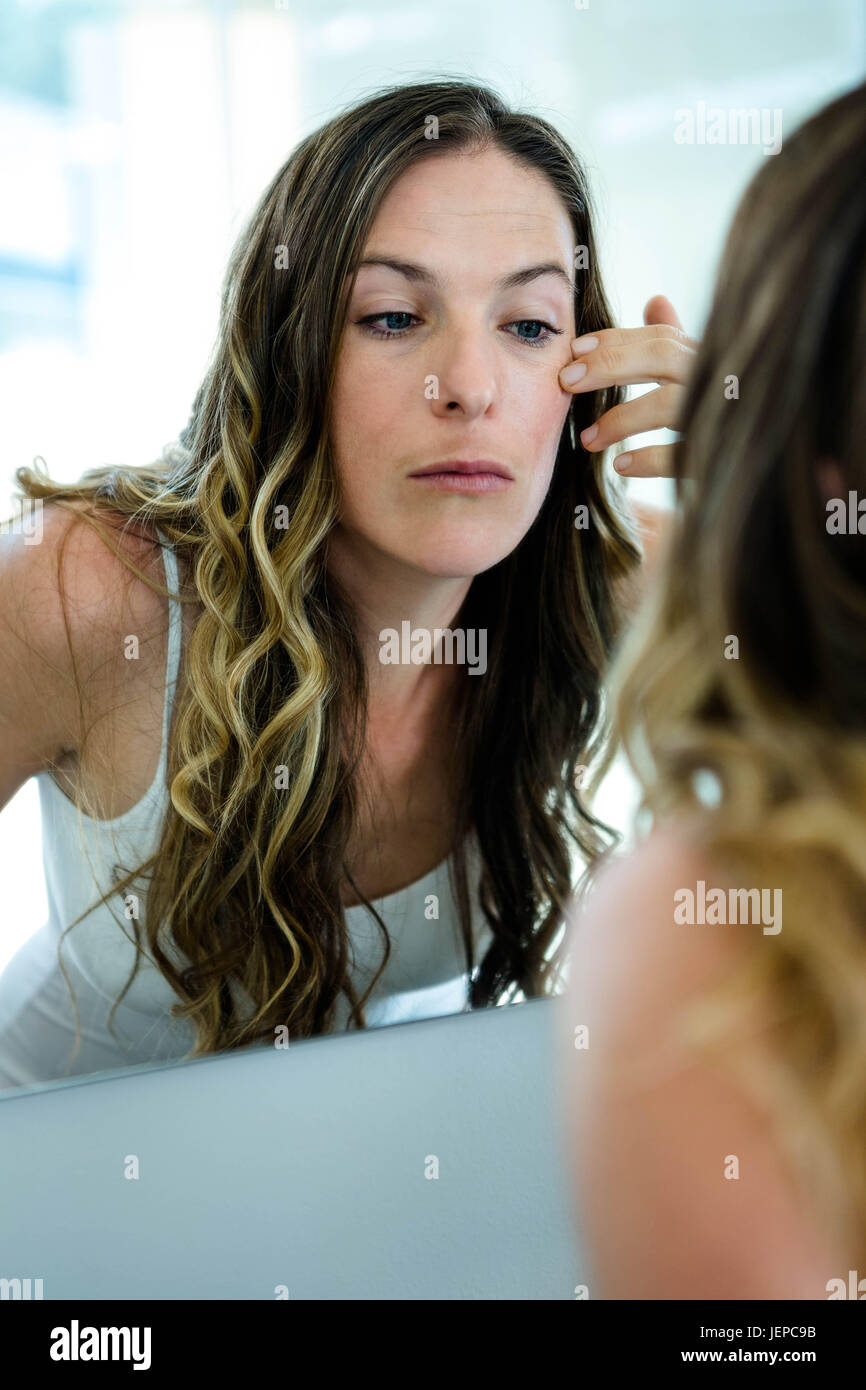 straight face woman inspecting her complexion Stock Photo - Alamy