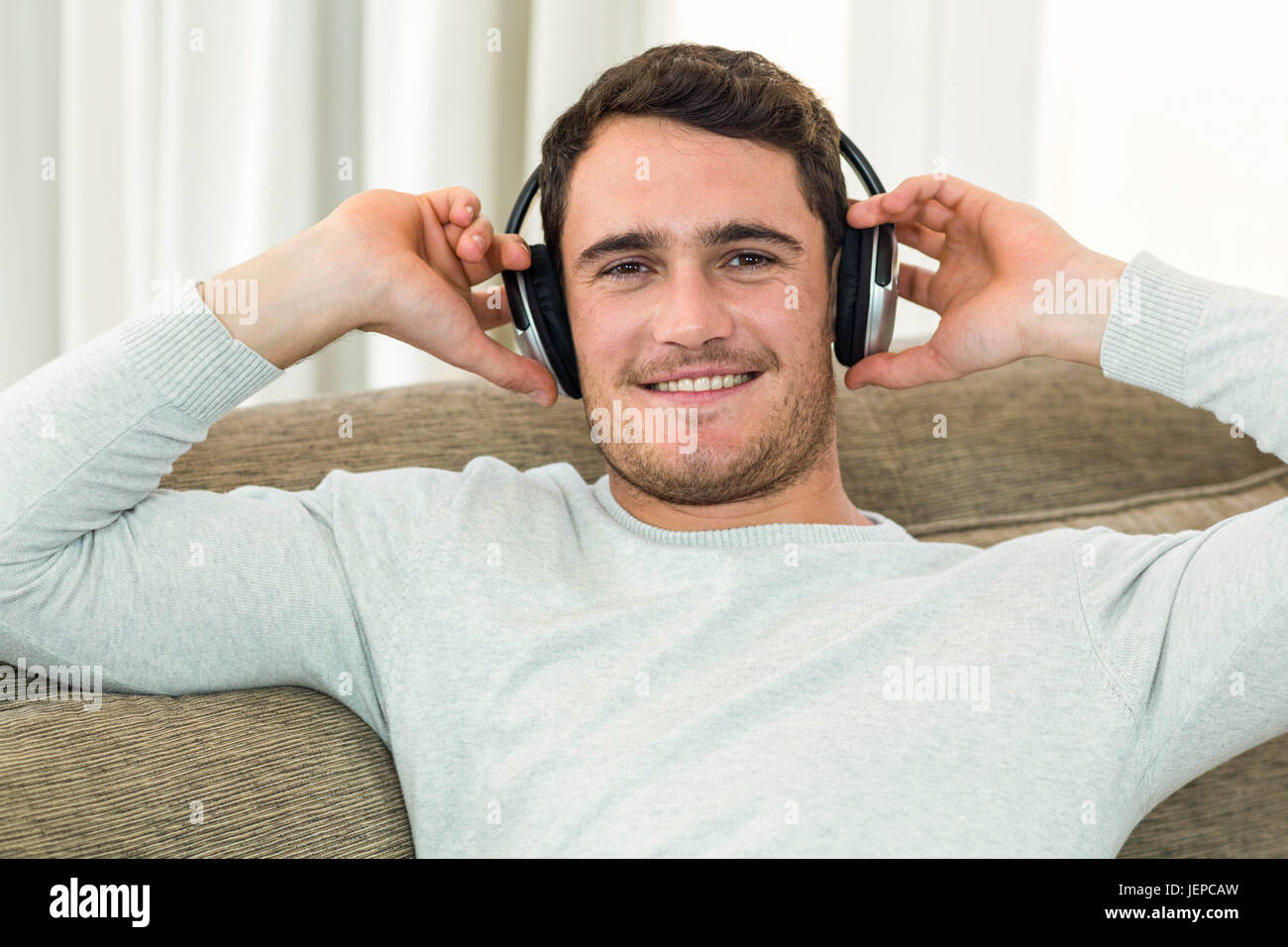 Portrait of young man listening to music Stock Photo - Alamy