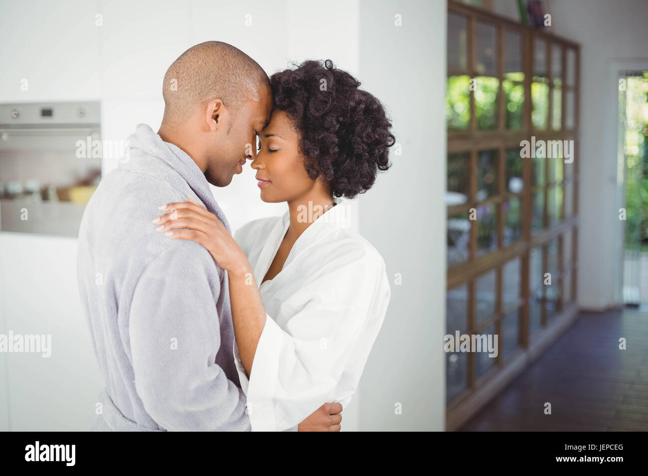 Beautiful couple hugging in kitchen hi-res stock photography and images ...