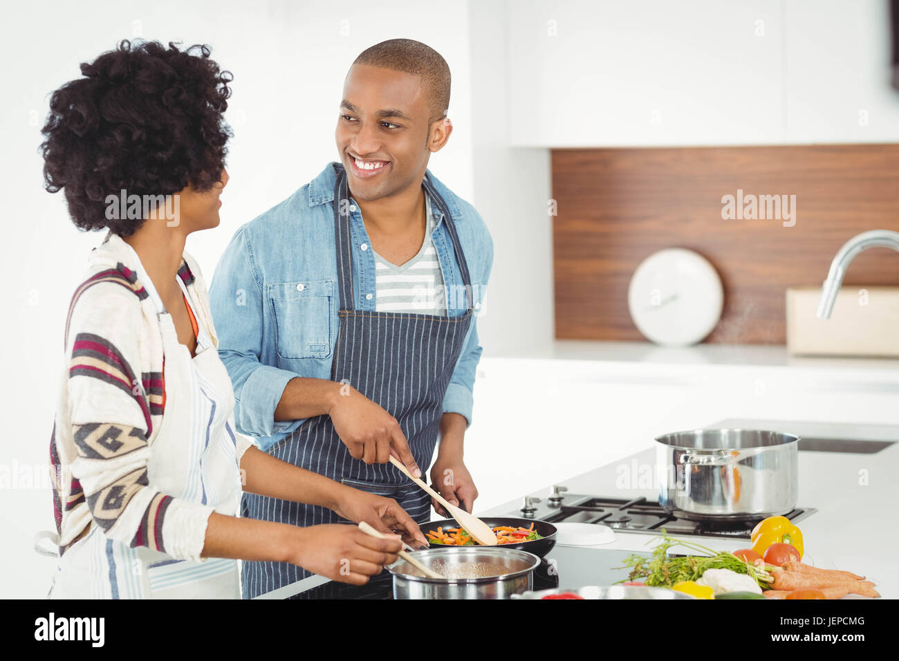 Happy couple cooking together Stock Photo - Alamy