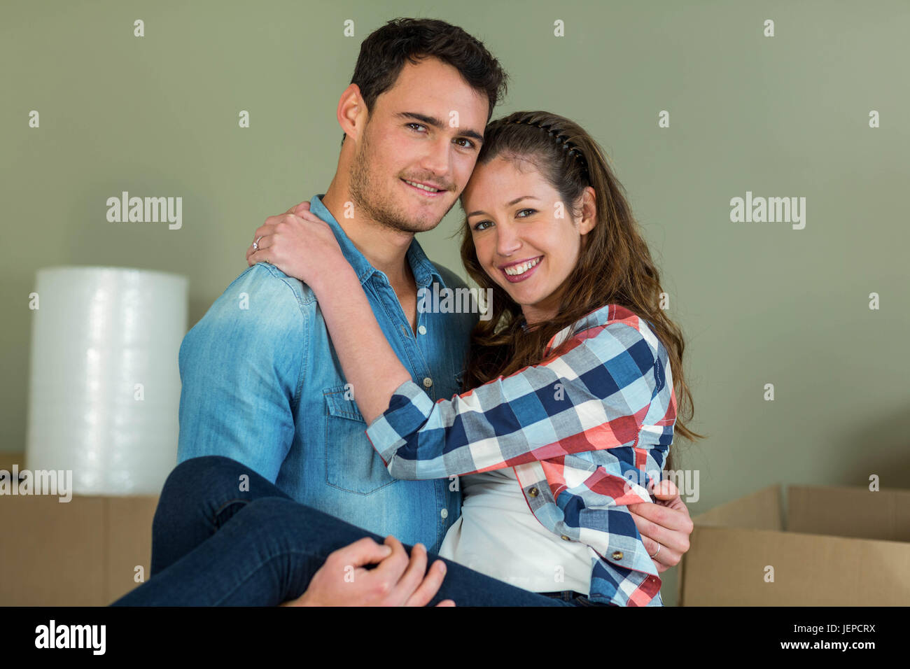 Man lifting woman in his arms Stock Photo - Alamy