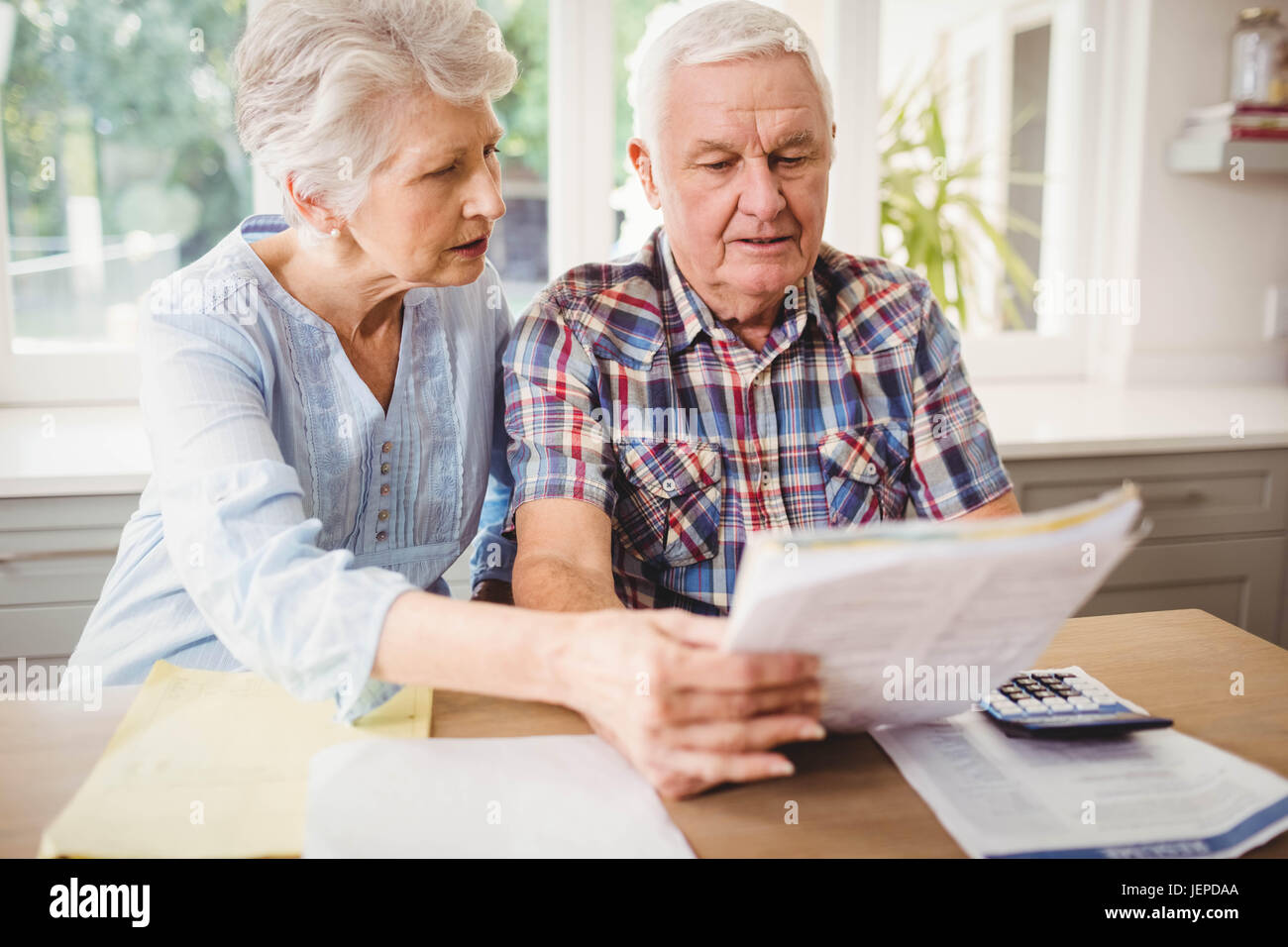 Worried senior couple checking their bills Stock Photo - Alamy