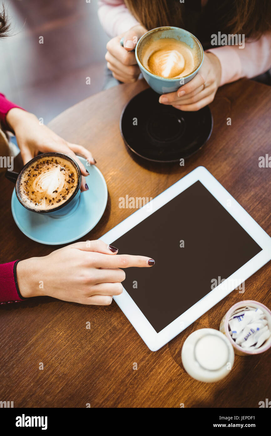 Friends using tablet together Stock Photo - Alamy