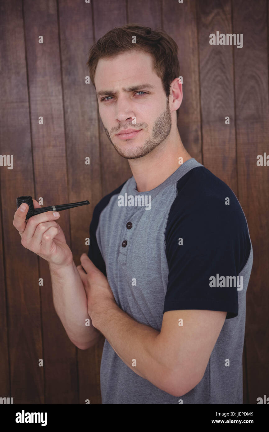 Handsome hipster smoking pipe Stock Photo - Alamy