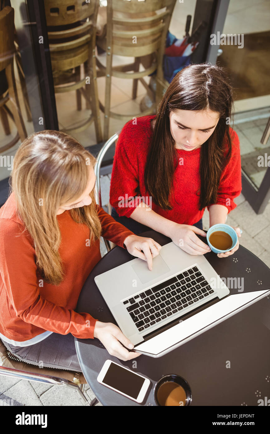 Friends using laptop together Stock Photo - Alamy