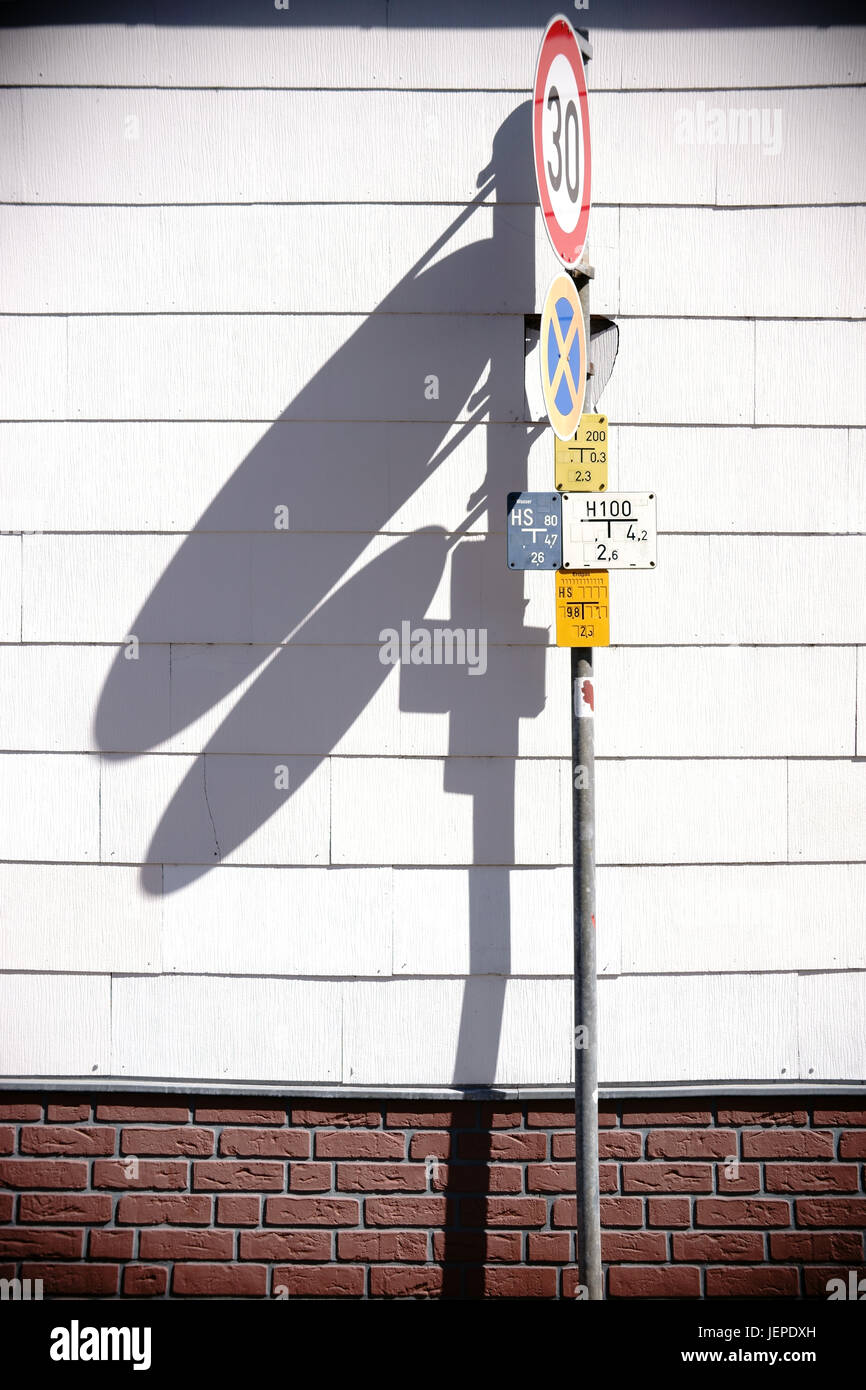 A vertical standing no parking and speed limit sign with water and gas ...