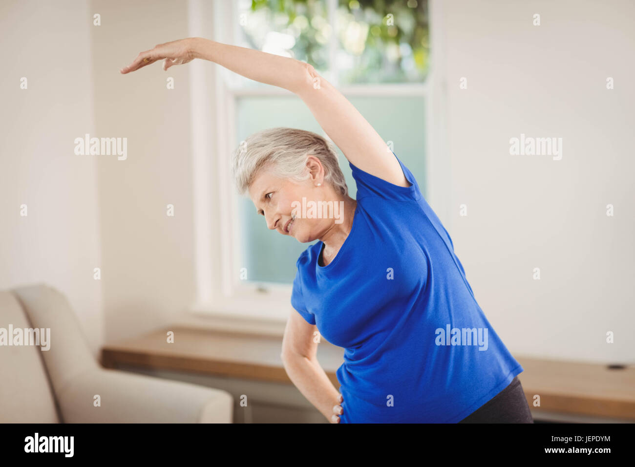 Woman performing stretching exercise hi-res stock photography and ...