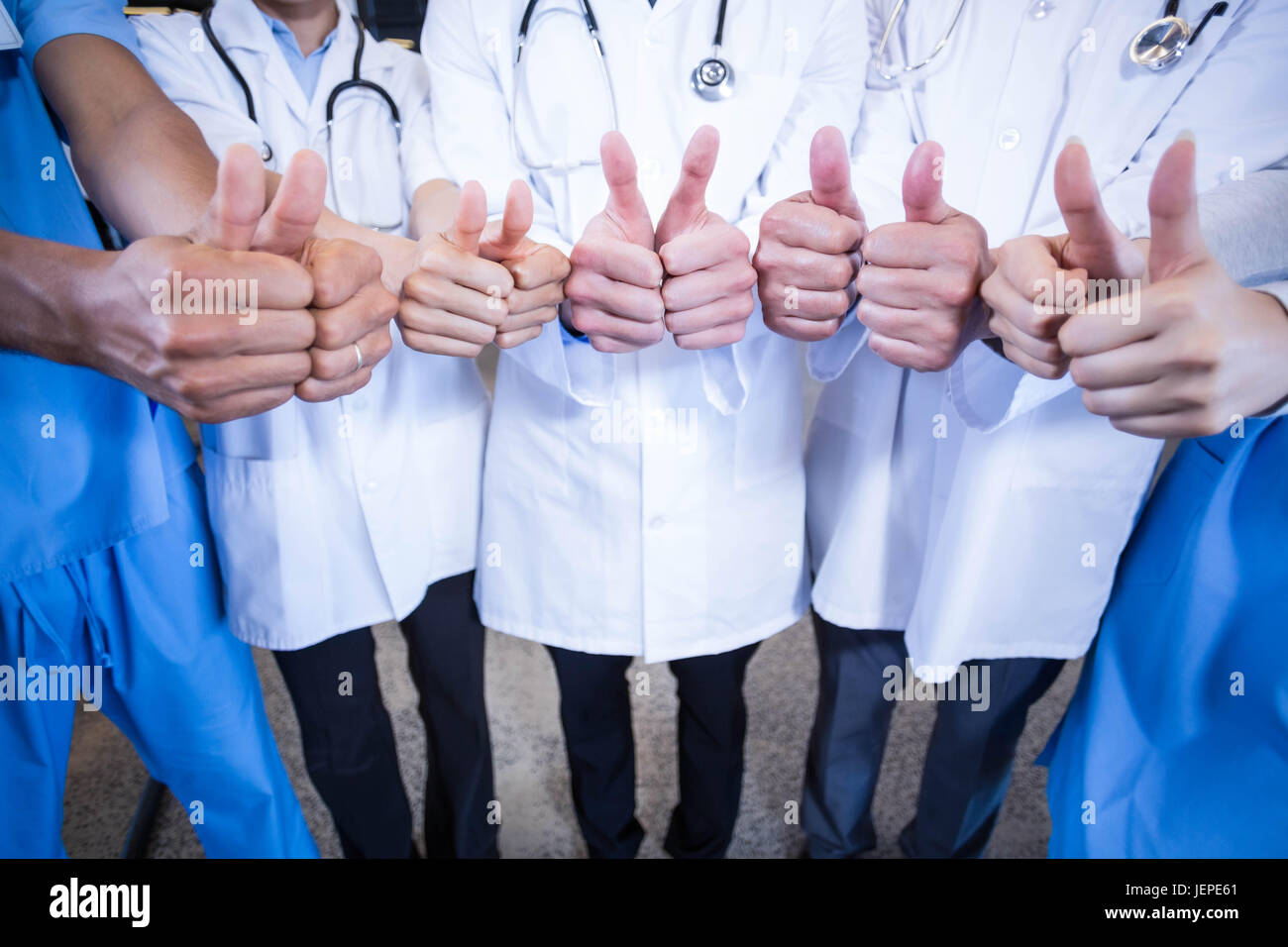 Medical team putting their thumbs up Stock Photo - Alamy
