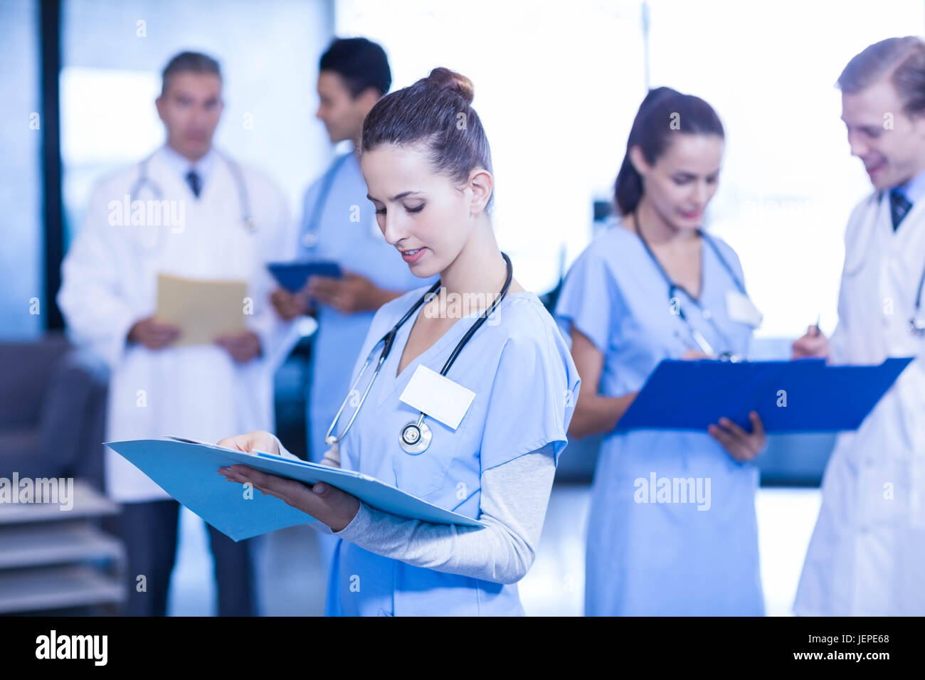Female doctor checking medical report Stock Photo - Alamy