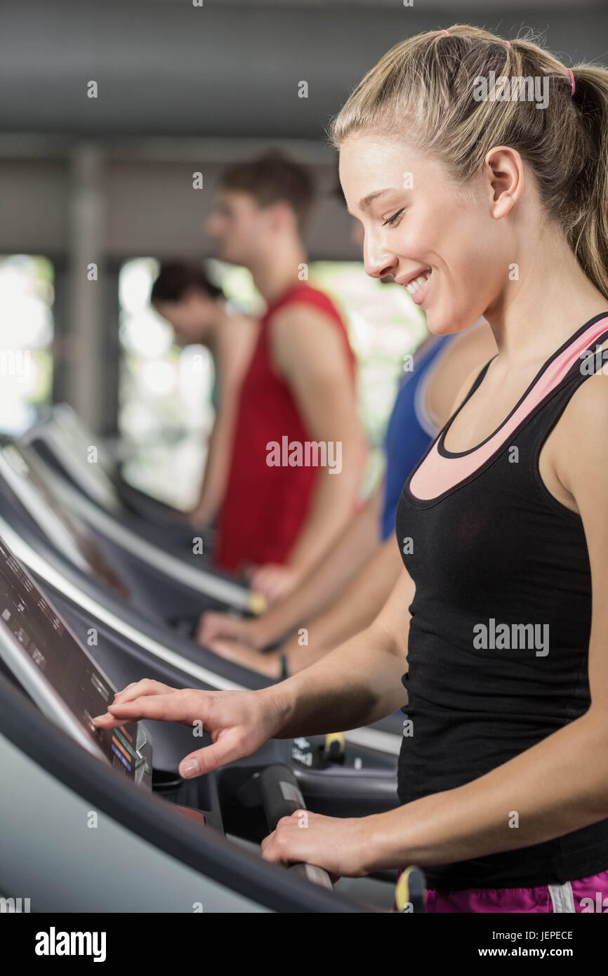 Fit woman running on treadmill Stock Photo - Alamy
