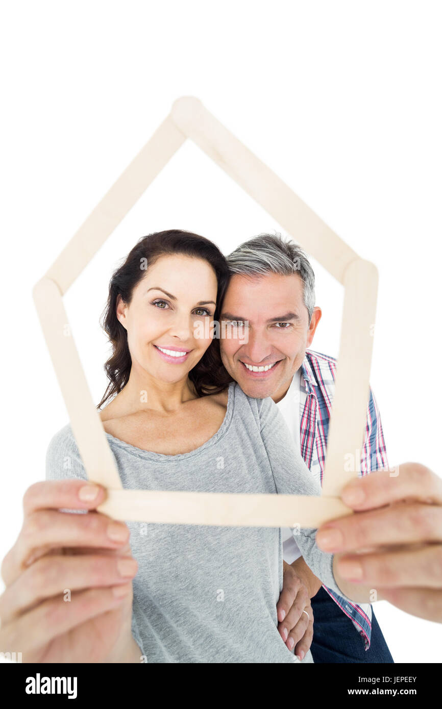 Couple holding house shape Stock Photo - Alamy